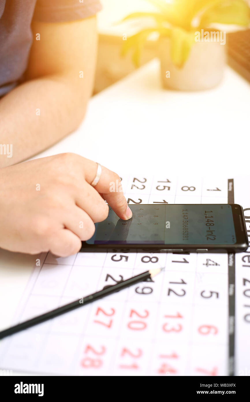 Picture of Man holding Calendar and marking on a date. Isolated on ...