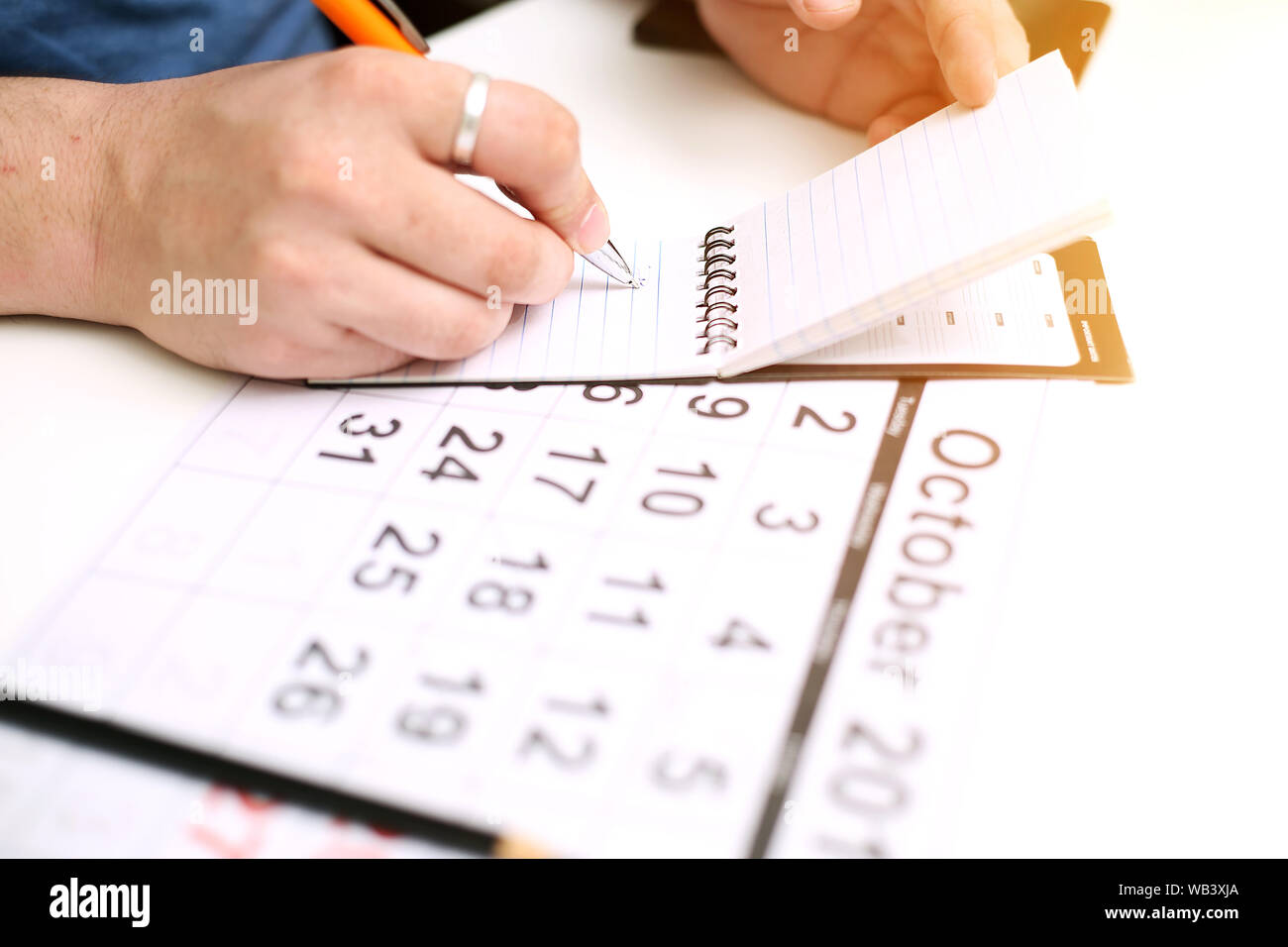 Picture of Man holding Calendar and marking on a date. Isolated on ...