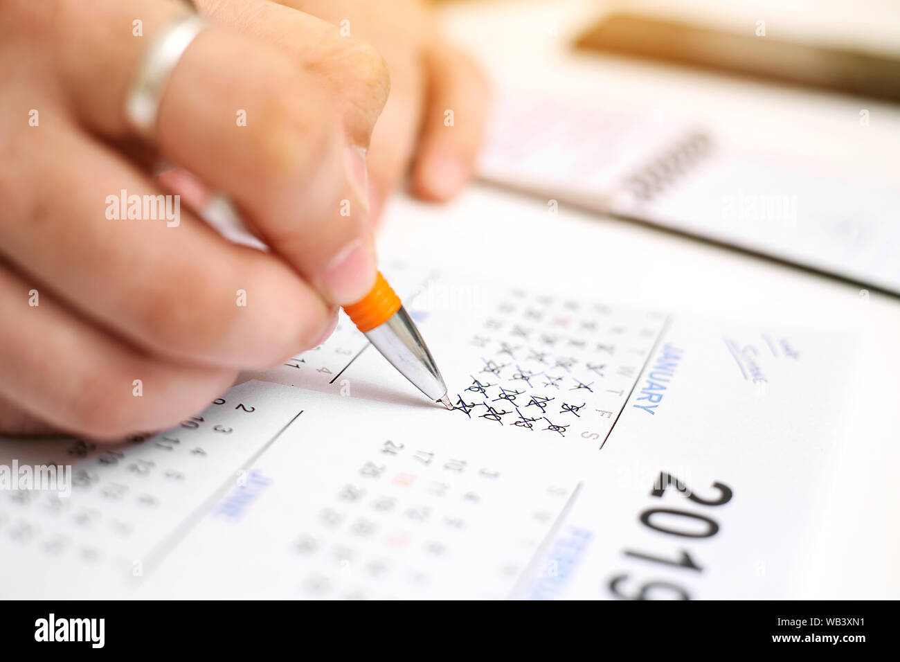 Picture of Man holding Calendar and marking on a date. Isolated on ...