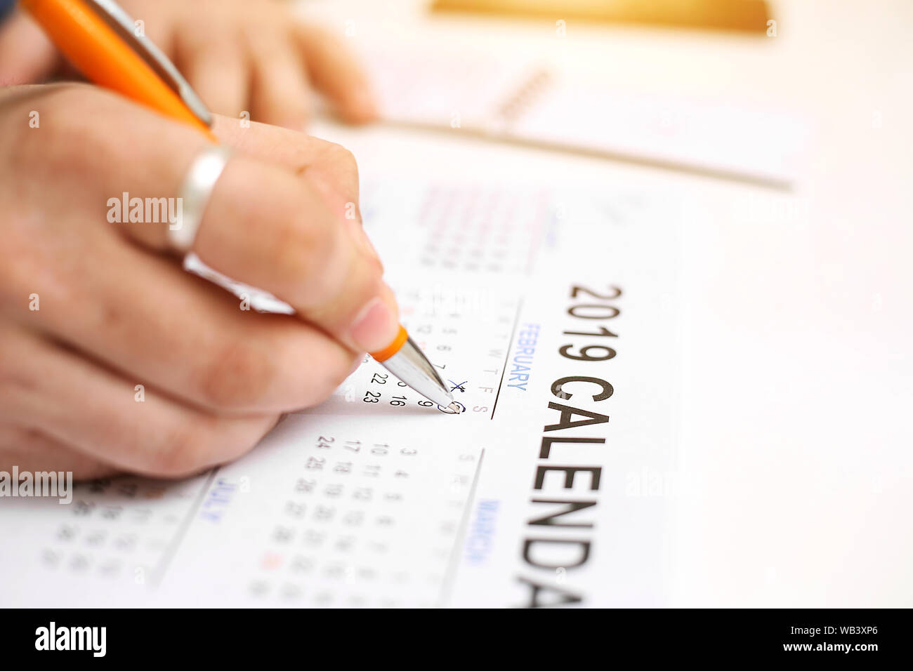 Picture of Man holding Calendar and marking on a date. Isolated on ...