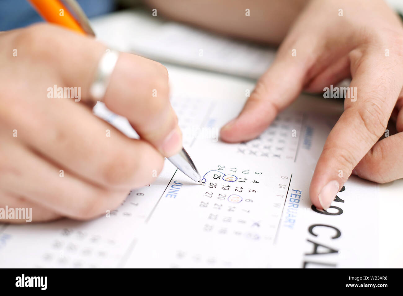 Picture of Man holding Calendar and marking on a date. Isolated on ...