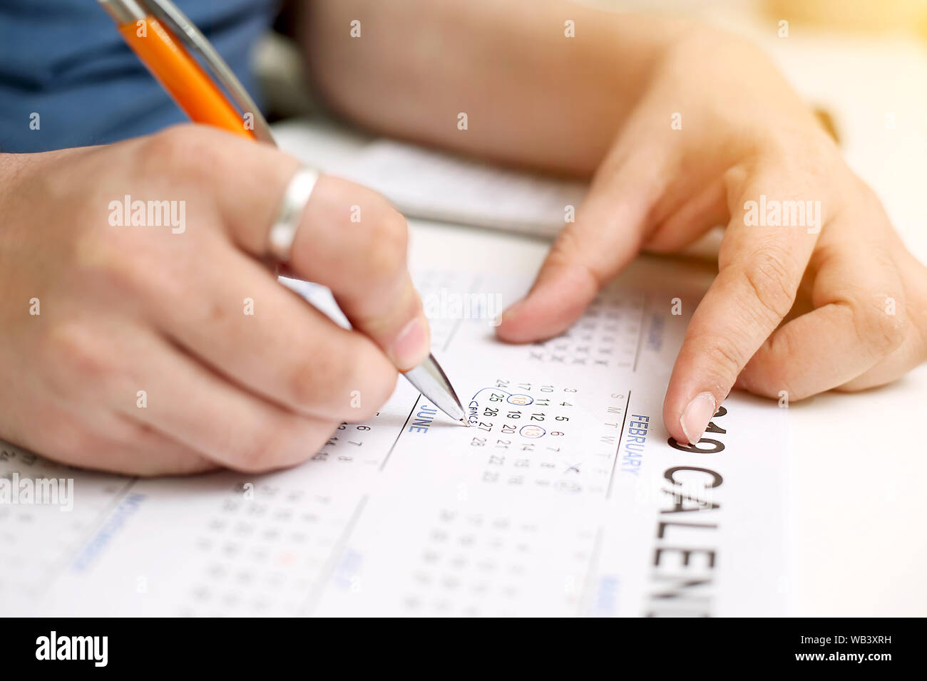 Picture of Man holding Calendar and marking on a date. Isolated on ...