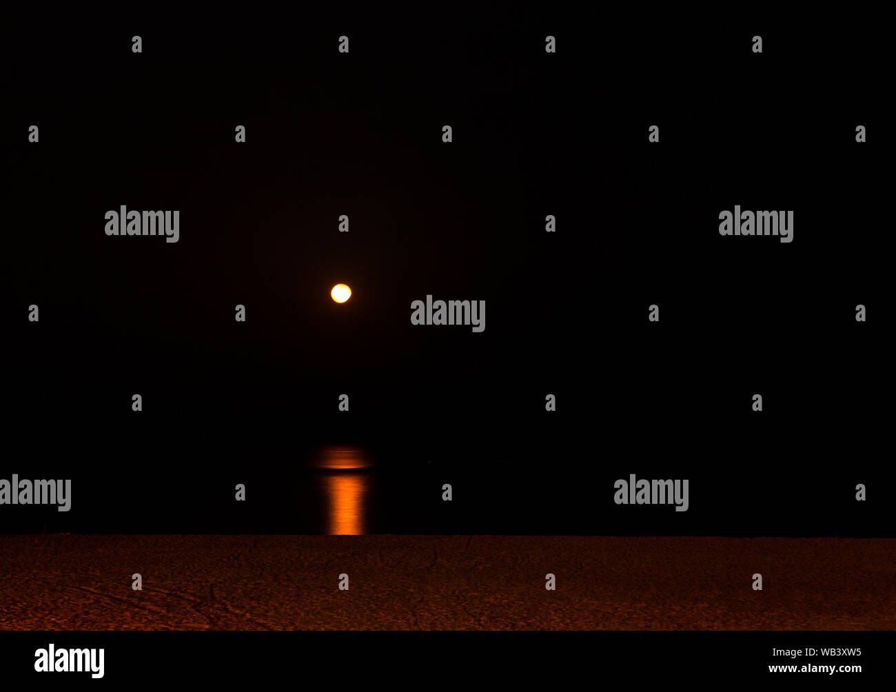 full moon on the dark sky over the sea Stock Photo - Alamy