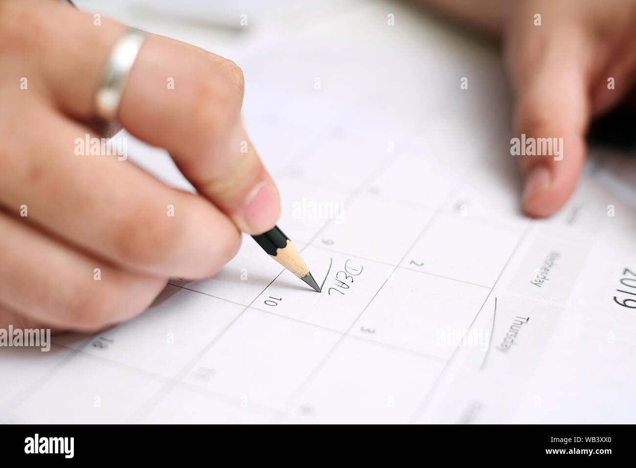 Picture of Man holding Calendar and marking on a date. Isolated on ...
