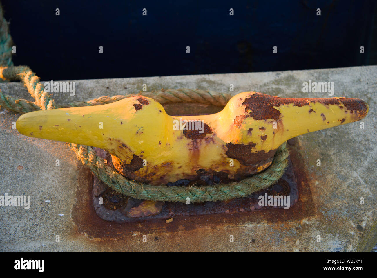 A short rope from a fishing boat to an old cleat on a pier, Gloucester ...