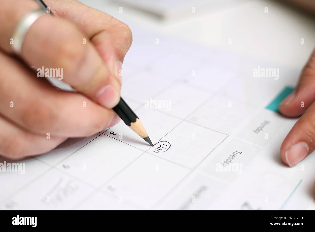 Picture of Man holding Calendar and marking on a date. Isolated on ...