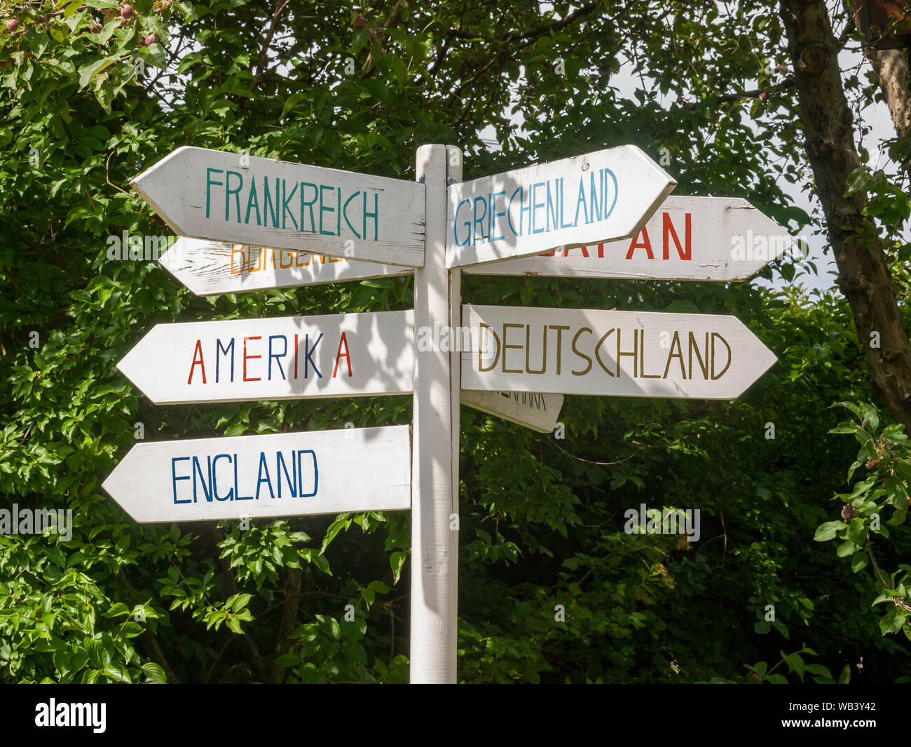 white wooden signpost with country names written in german Stock Photo ...