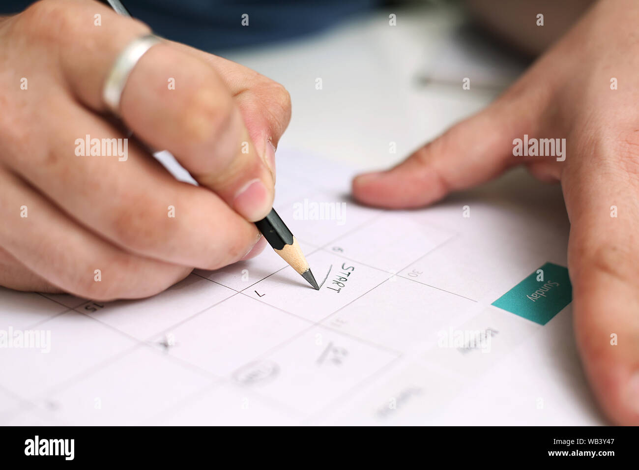 Picture of Man holding Calendar and marking on a date. Isolated on ...