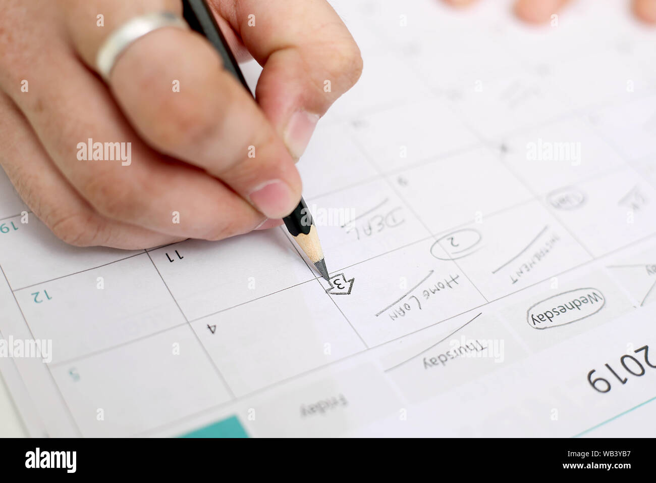 Picture of Man holding Calendar and marking on date. Isolated on white ...