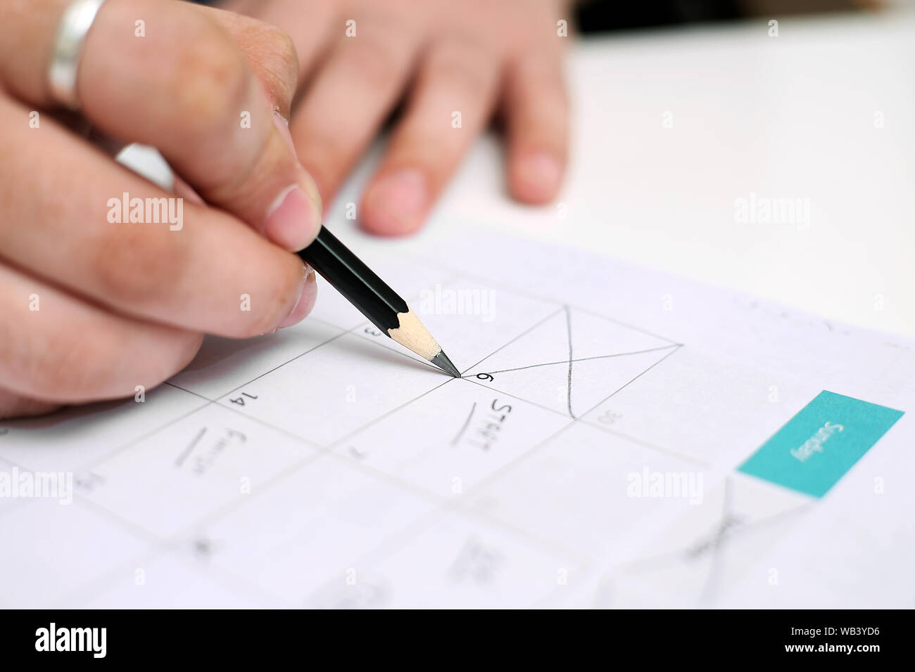 Picture of Man holding Calendar and marking on a date. Isolated on ...
