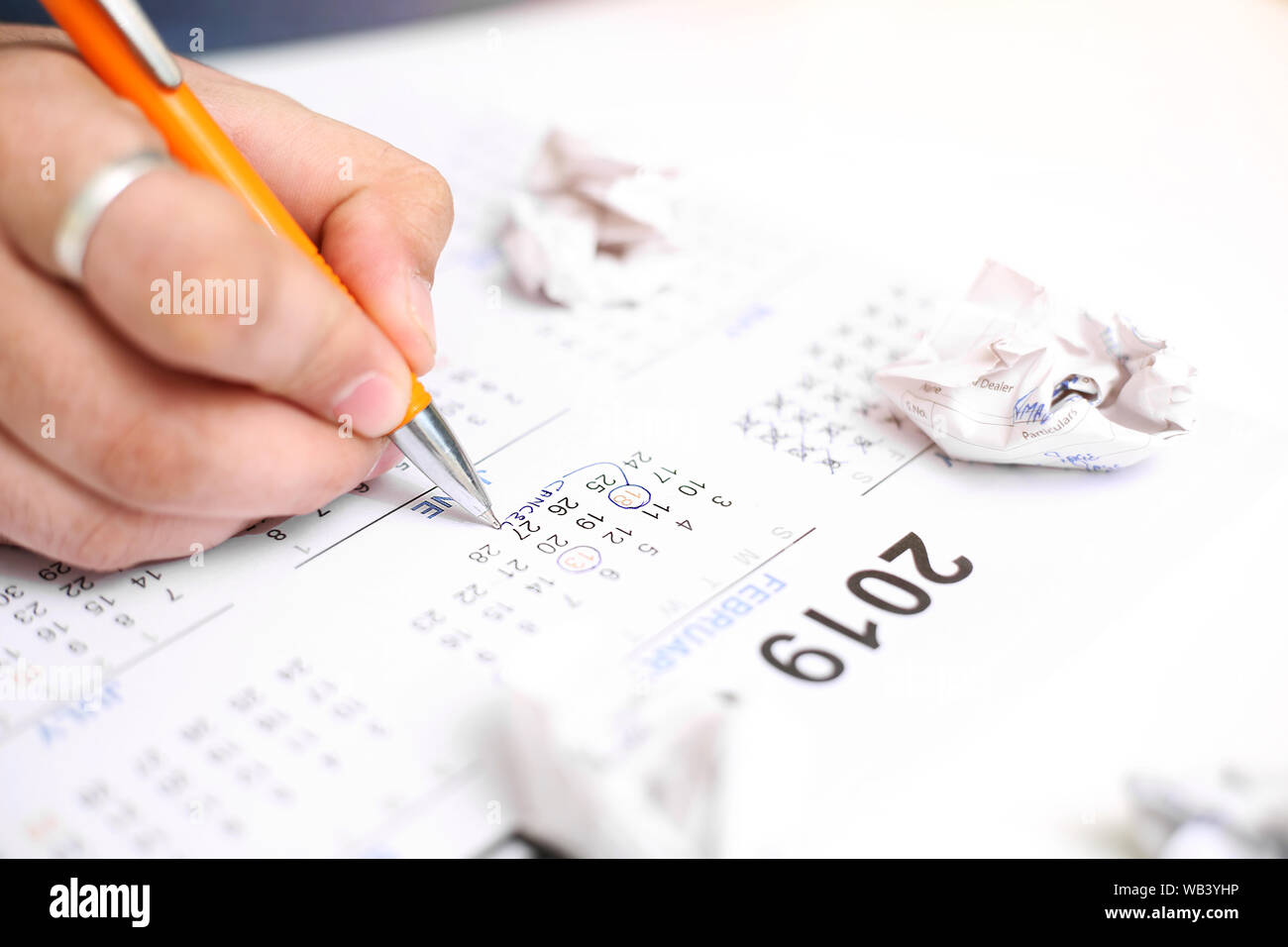 Picture of Man holding Calendar and marking on date. Isolated on white ...