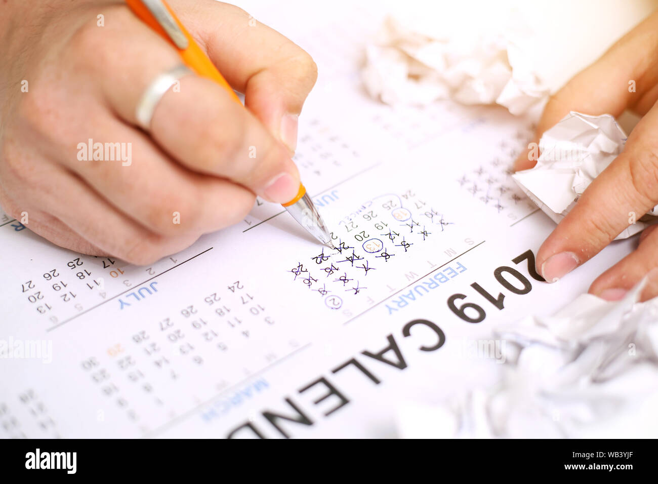 Picture of Man holding Calendar and marking on a date. Isolated on ...
