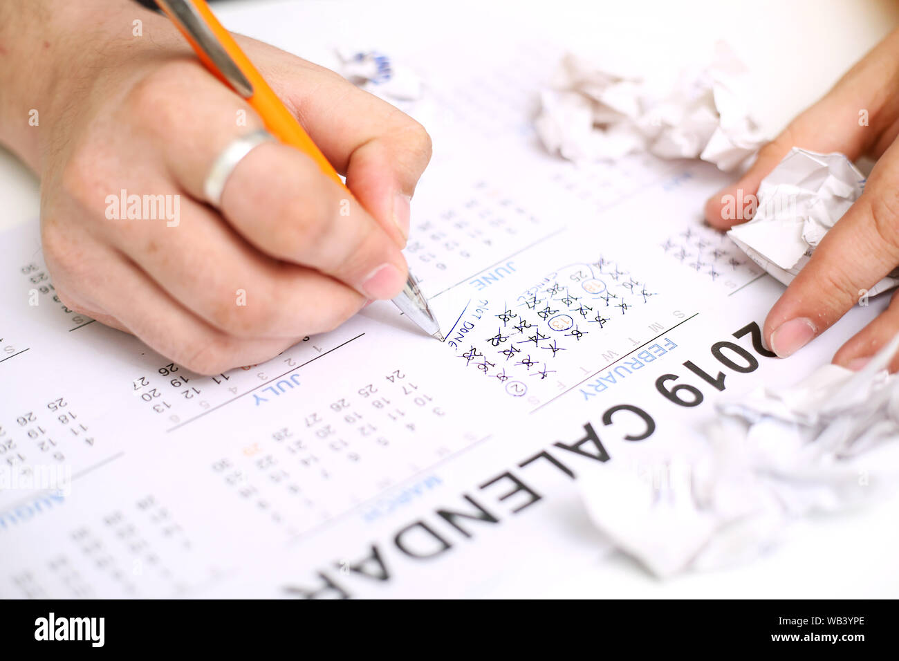 Picture of Man holding Calendar and marking on a date. Isolated on ...