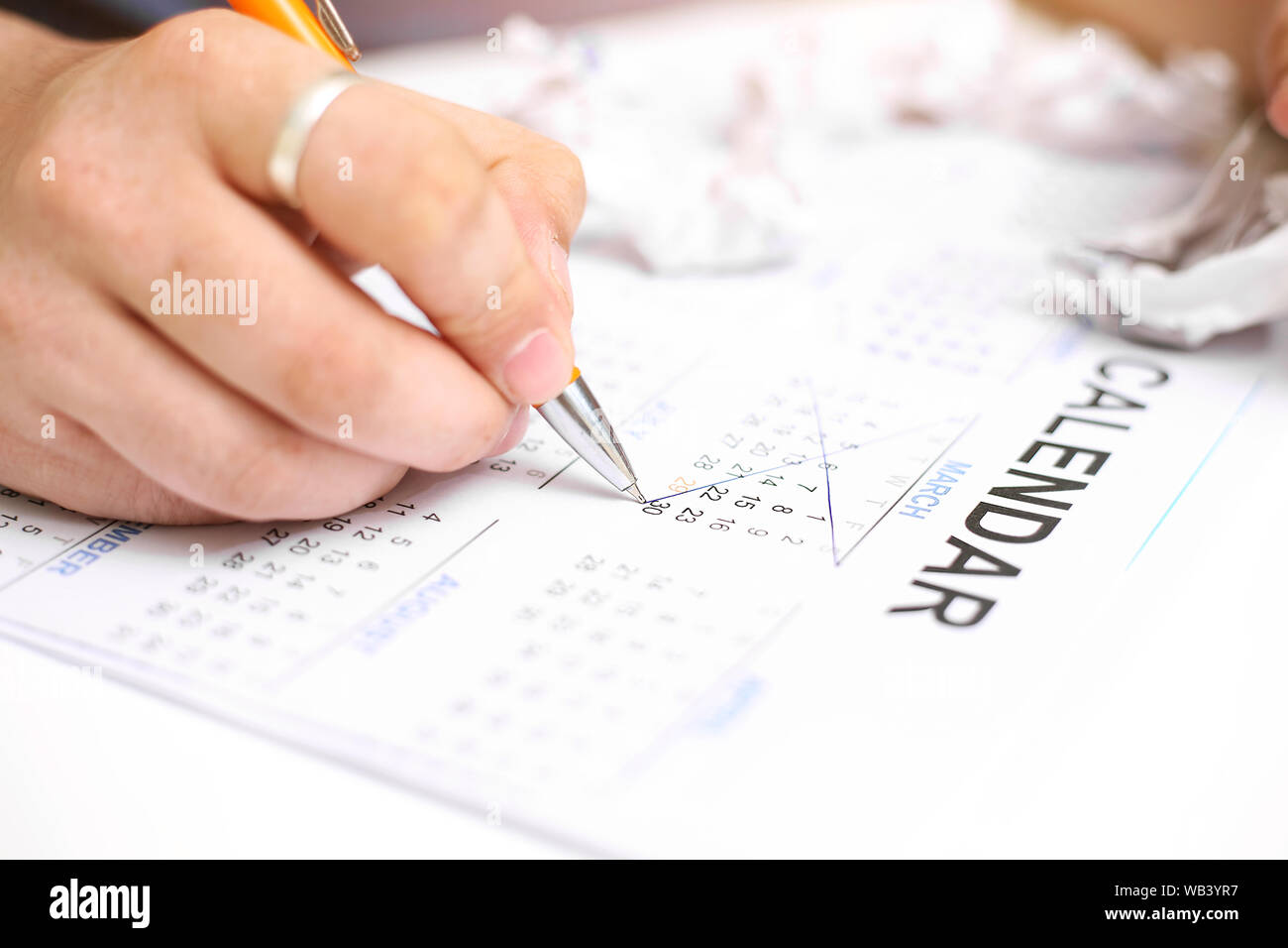 Picture of Man holding Calendar and marking on date. Isolated on white ...