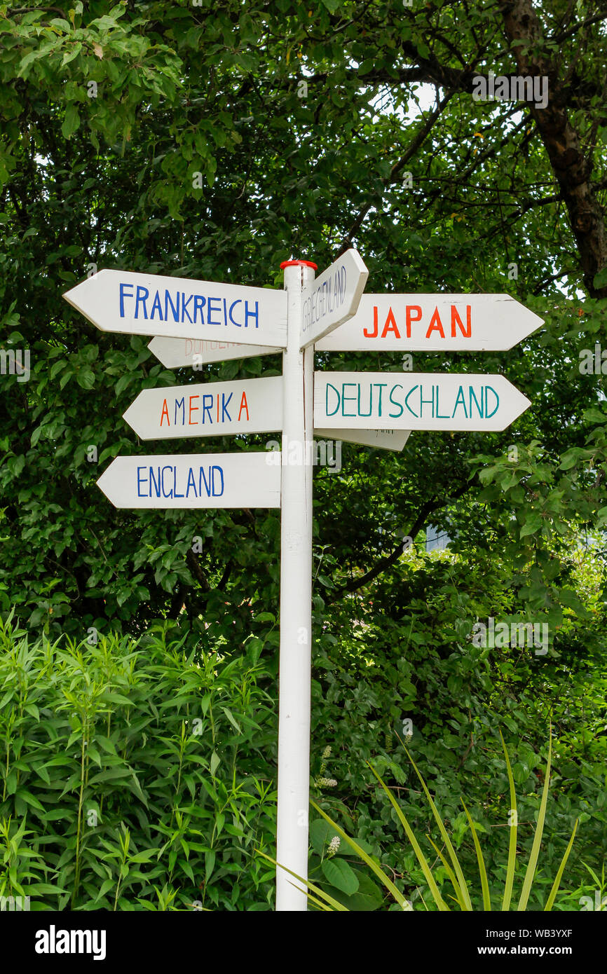 white wooden signpost with country names written in german Stock Photo ...