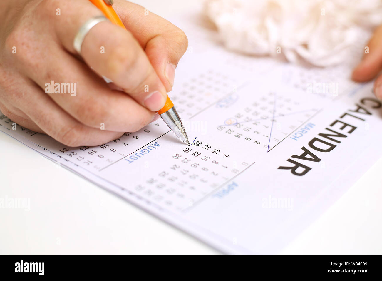 Picture of Man holding Calendar and marking on a date. Isolated on ...