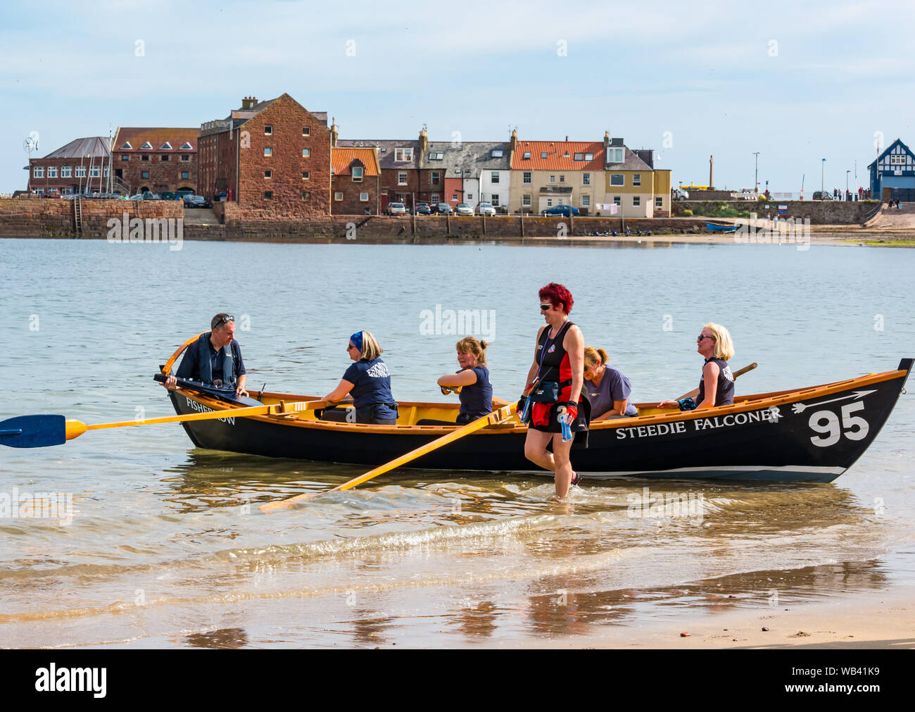 North Berwick, Scotland, UK, 24 August 2019. Colourful rowing skiffs ...