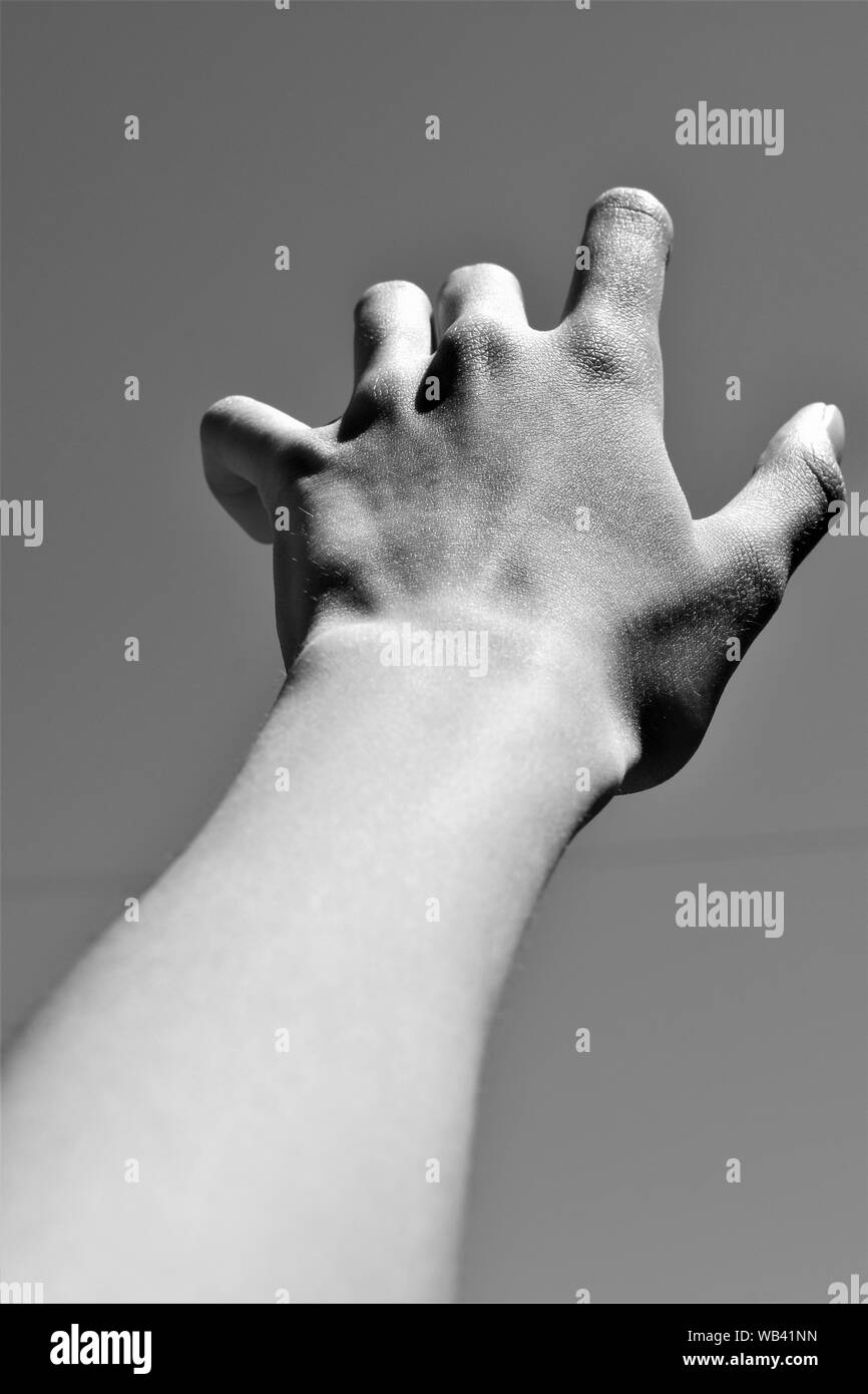 Black and white photo, hand of a person who's dropping Stock Photo - Alamy