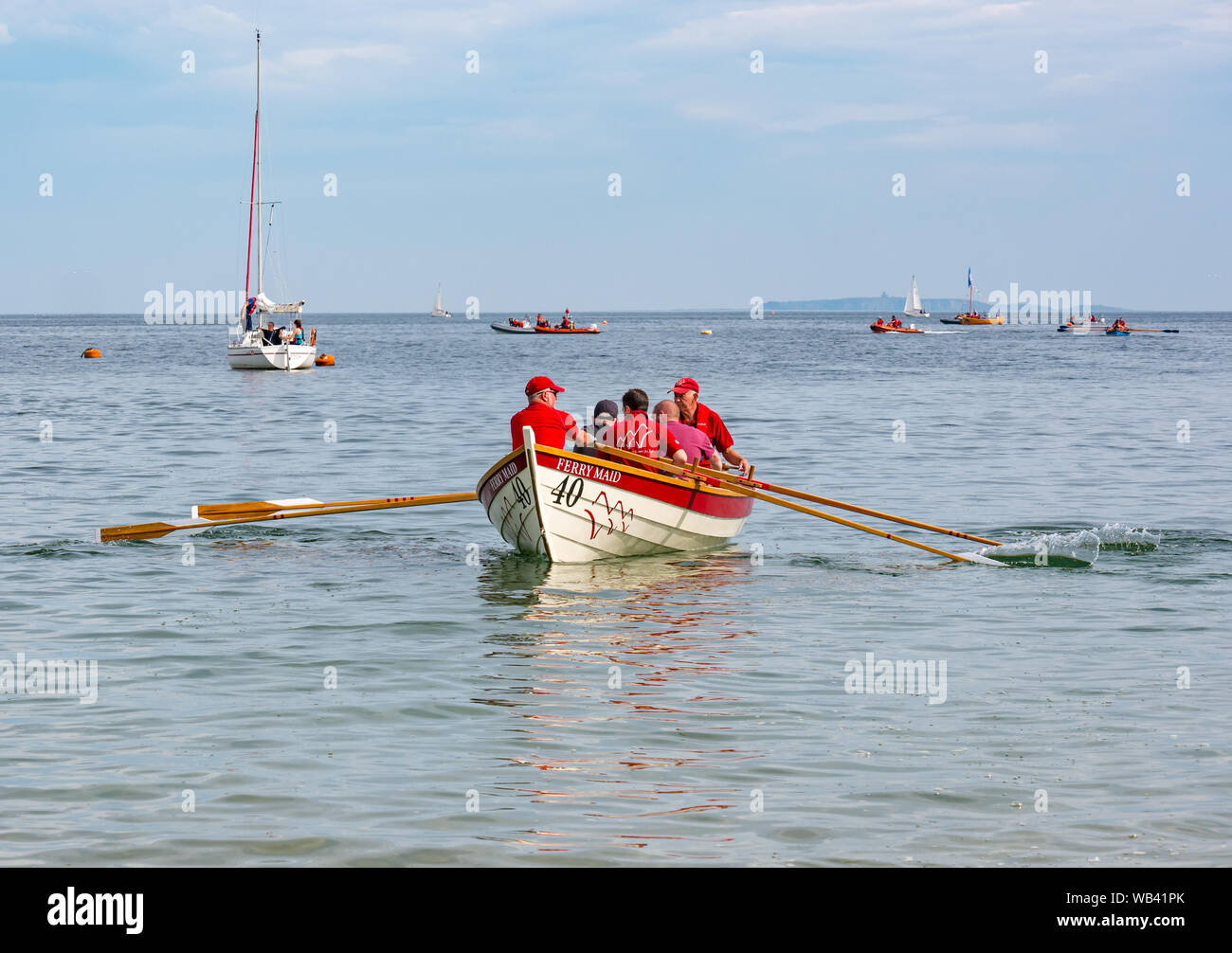 North Berwick, Scotland, UK, 24 August 2019. Colourful rowing skiffs ...