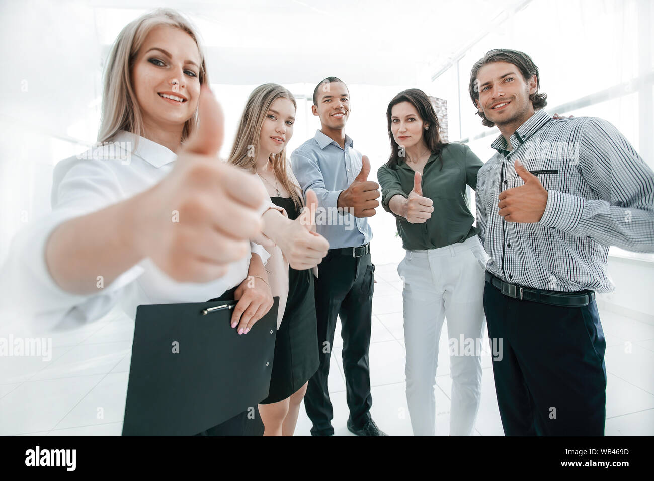 successful multinational business team showing thumb up.the concept of ...