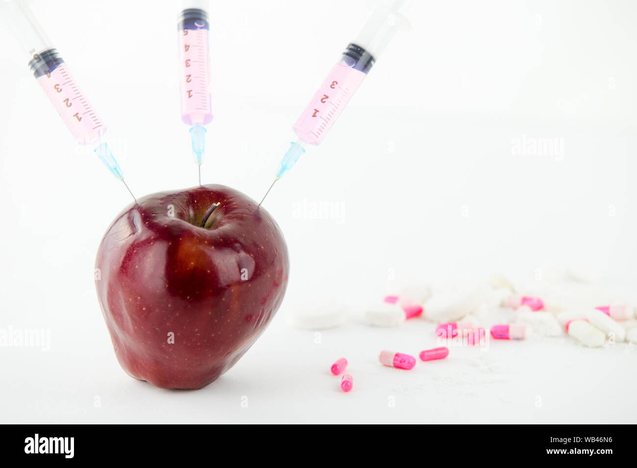 Concept: human GMO manipulation of nature and relative poisoned fruits ...