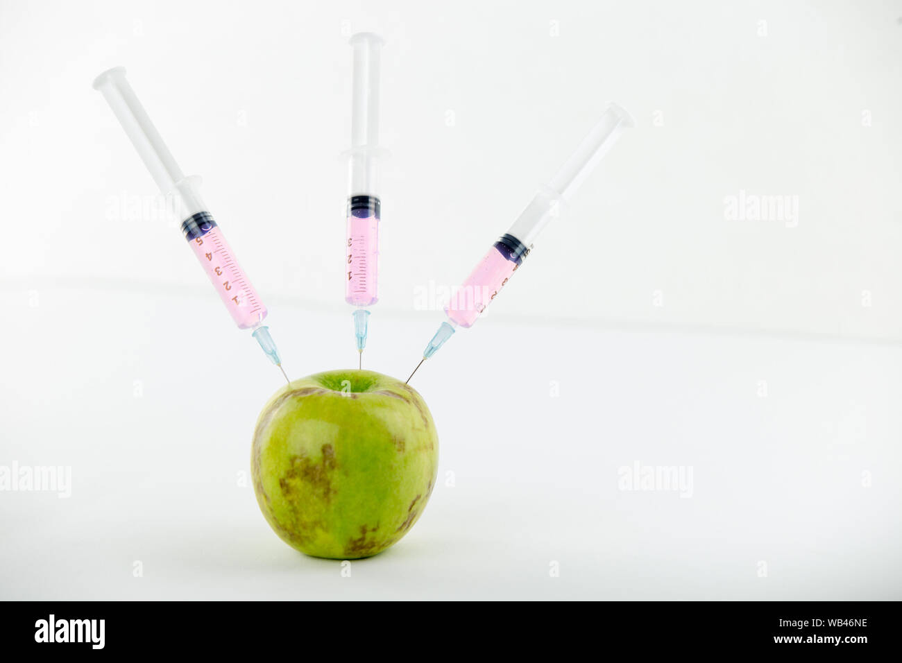 Concept: human GMO manipulation of nature and relative poisoned fruits ...