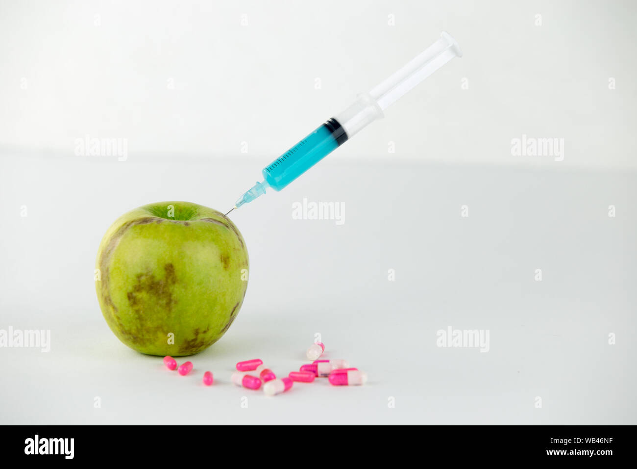 Concept: human GMO manipulation of nature and relative poisoned fruits ...