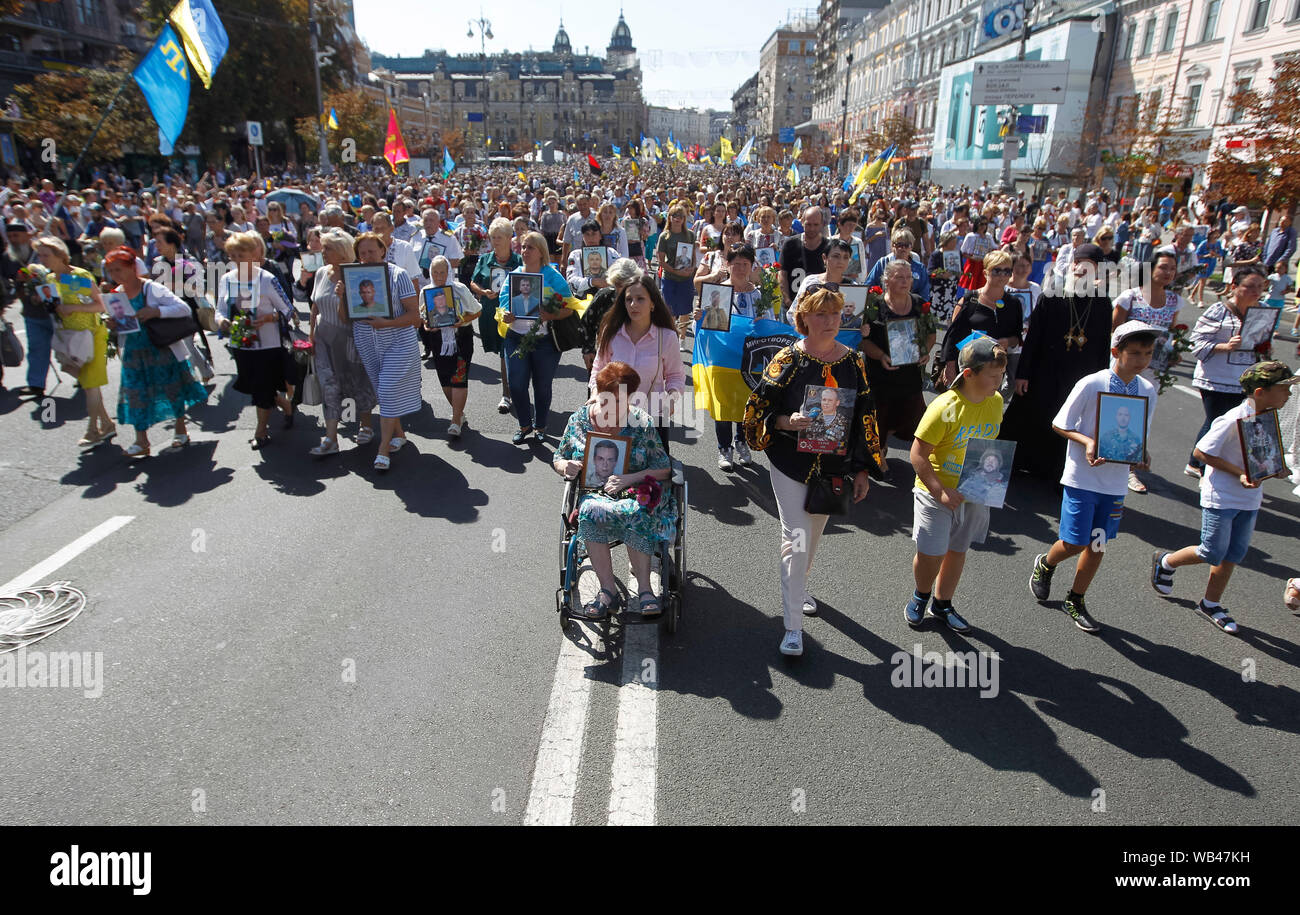 Relatives carry portraits of Ukrainian soldiers at the Independence ...