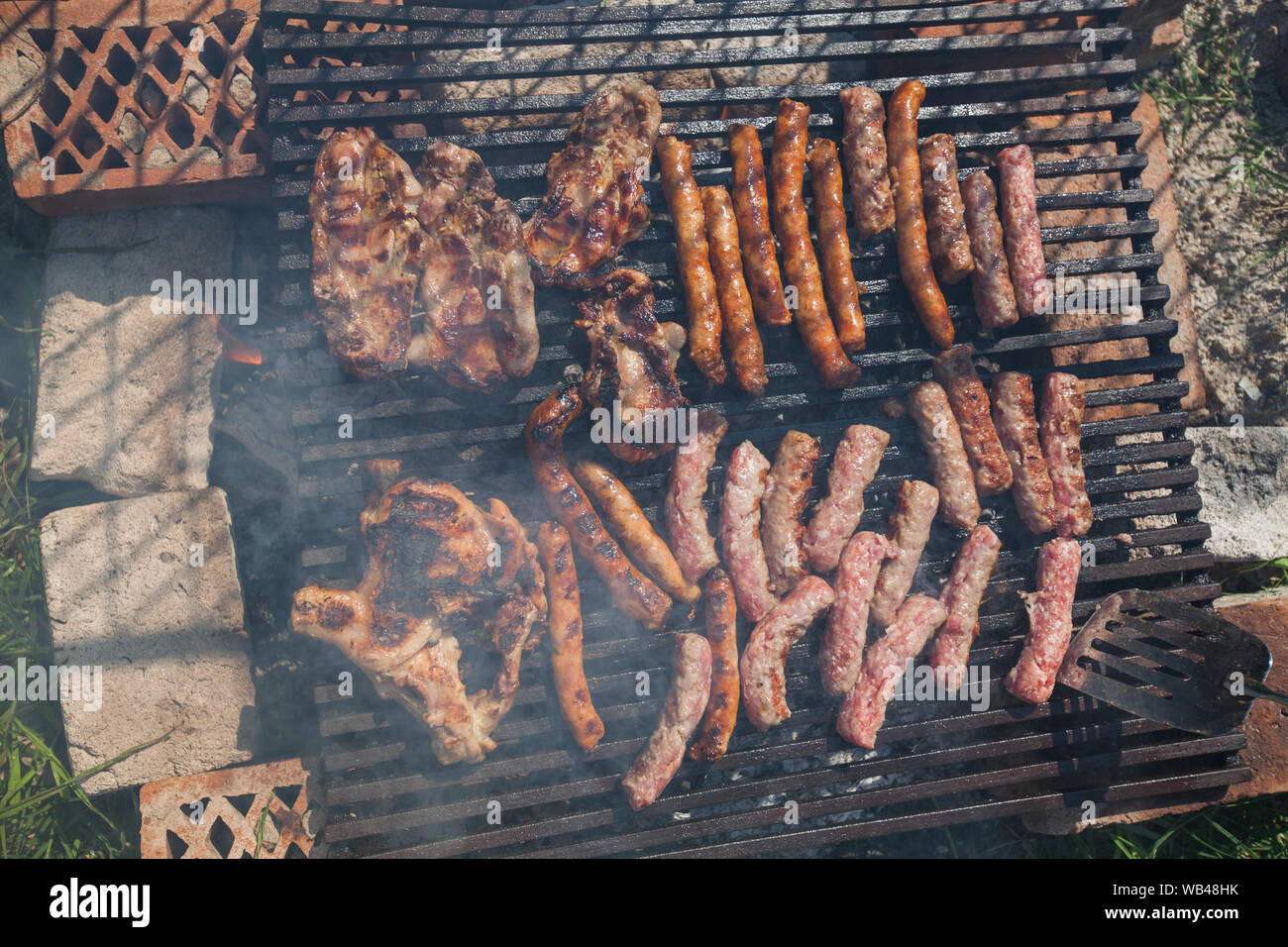 Grilled mixed meat on barbecue grill , outdoor preparing food Stock ...