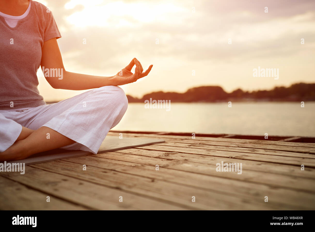 Woman meditate in yoga pose on river, concept Stock Photo - Alamy