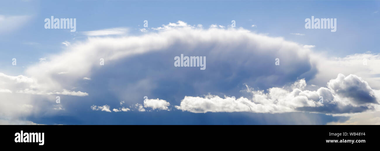 cloudscape, panorama, backdrop - blue sky and a big cumulonimbus cloud ...