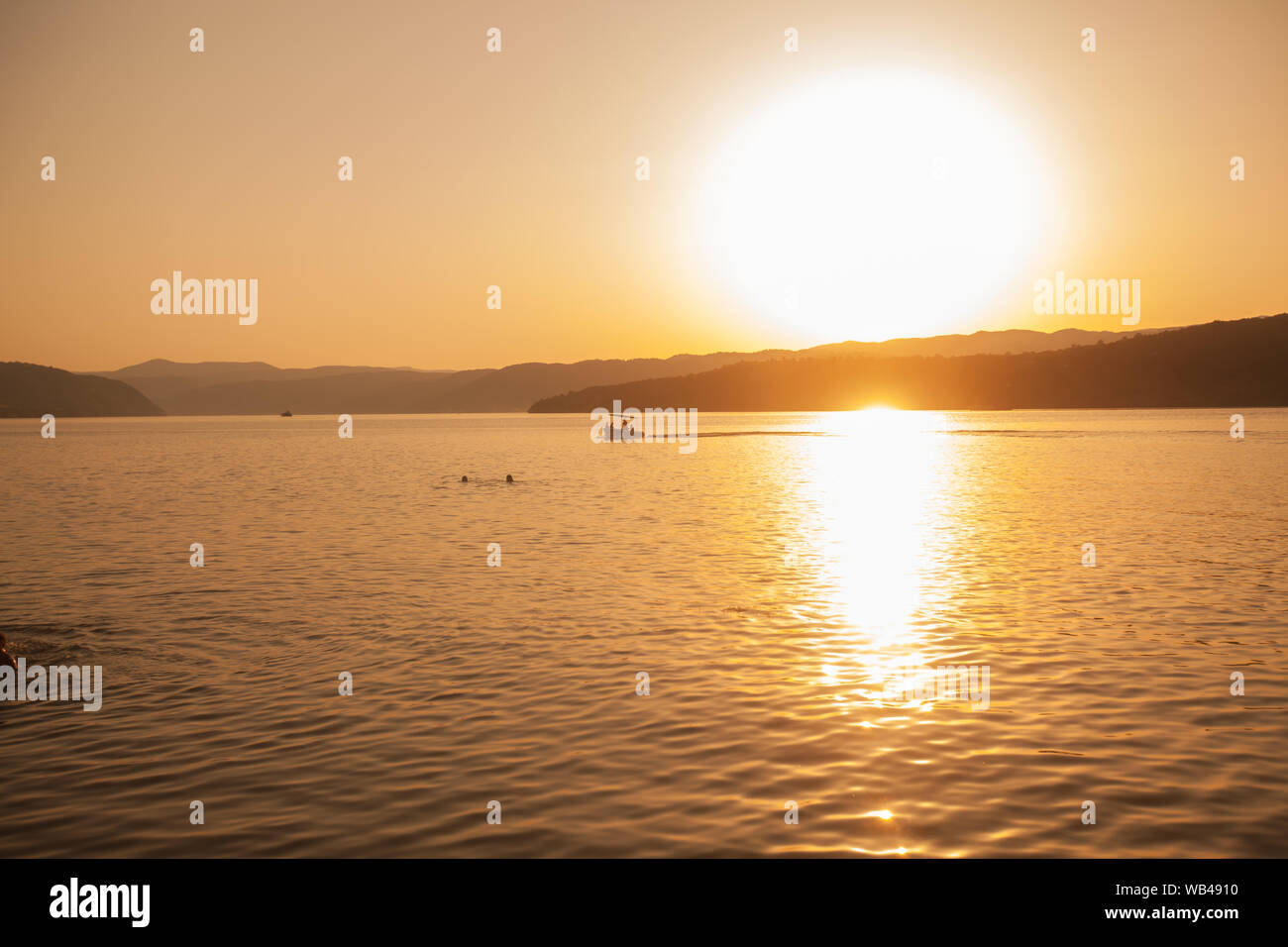 Beautiful sunset over river Danube with sun light reflection over water ...
