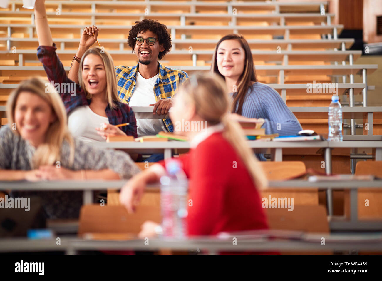 Happy girl student in a successful exam in a classroom Stock Photo - Alamy