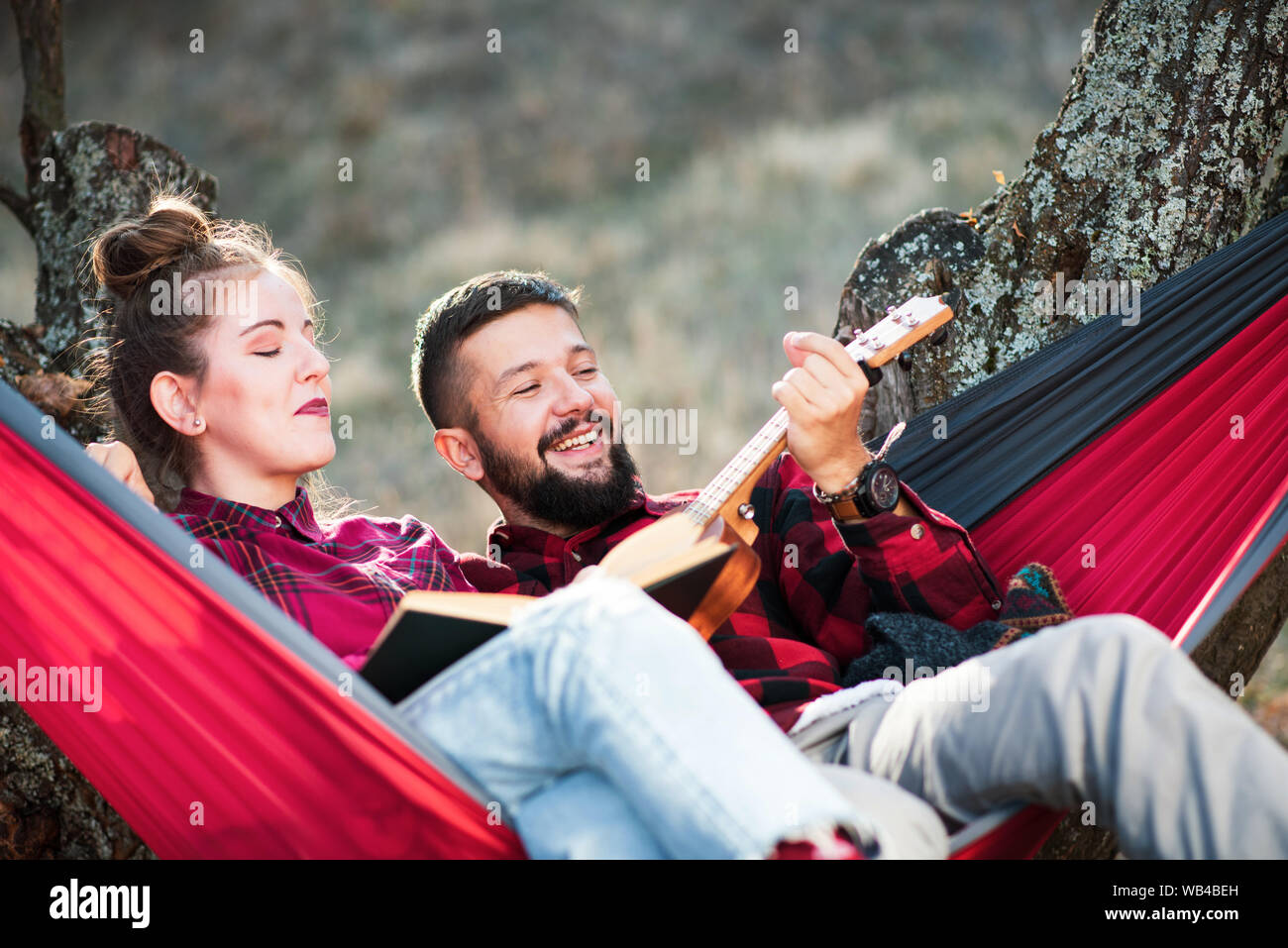 Couple having fun in a hammock on a picnic outdoors Stock Photo - Alamy