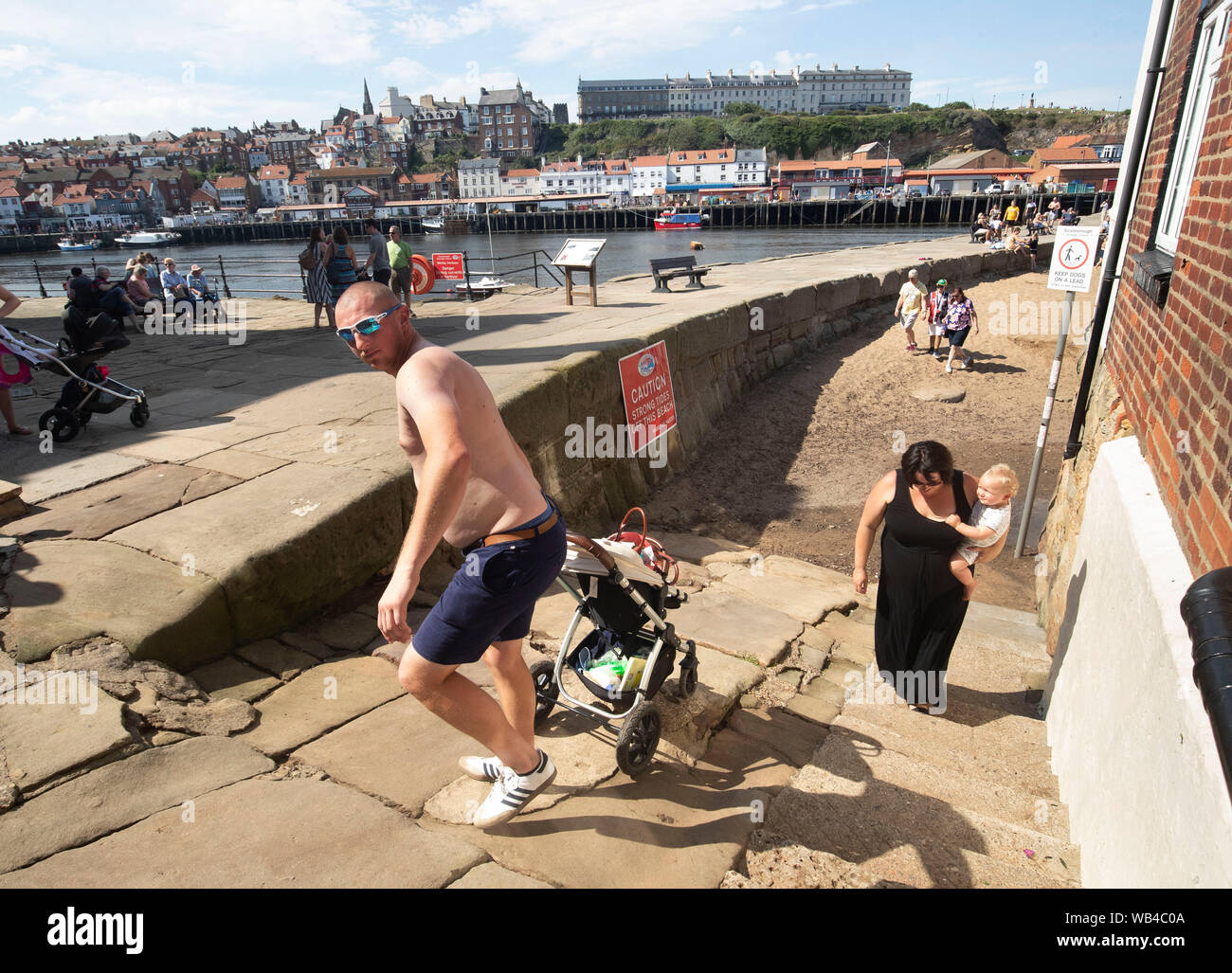 People enjoy the weather at Whitby in Yorkshire, as a bank holiday ...