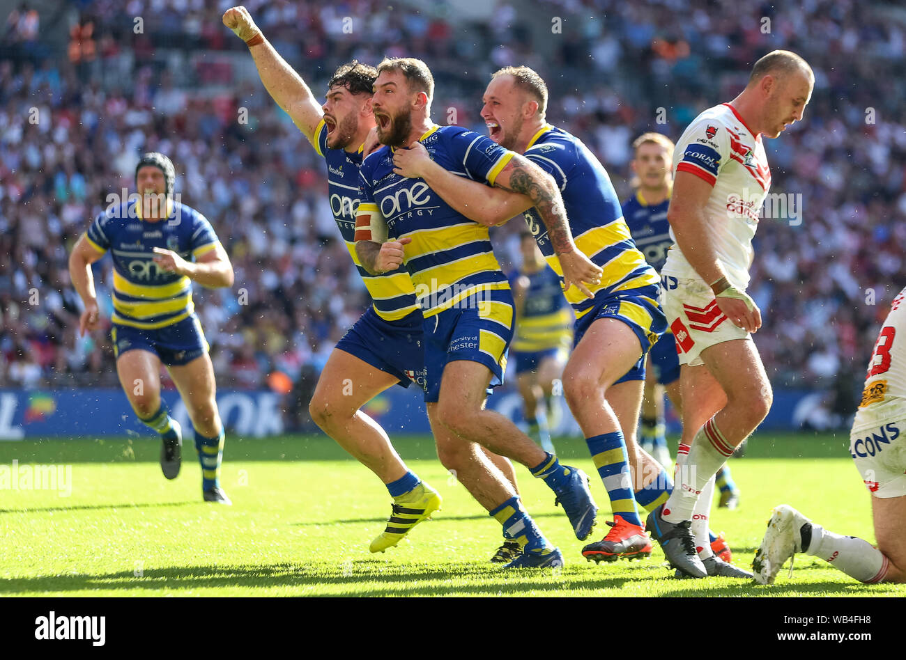 Warrington's Daryl Clark celebrates scoring a try during the Coral ...