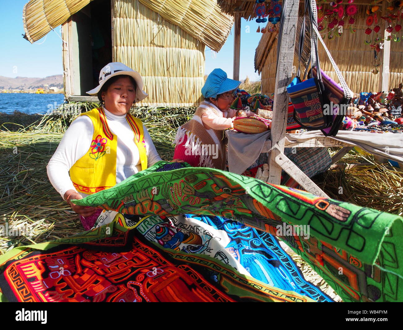 A woman and her son, Uro indigenous, offering their crafts for sale ...