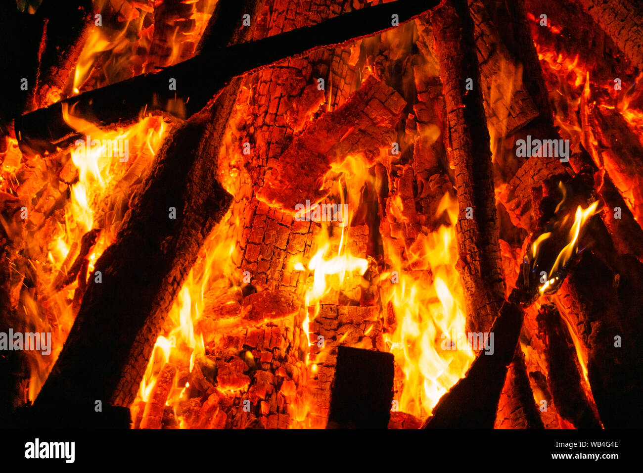 background - flame over burning coals in the darkness Stock Photo - Alamy