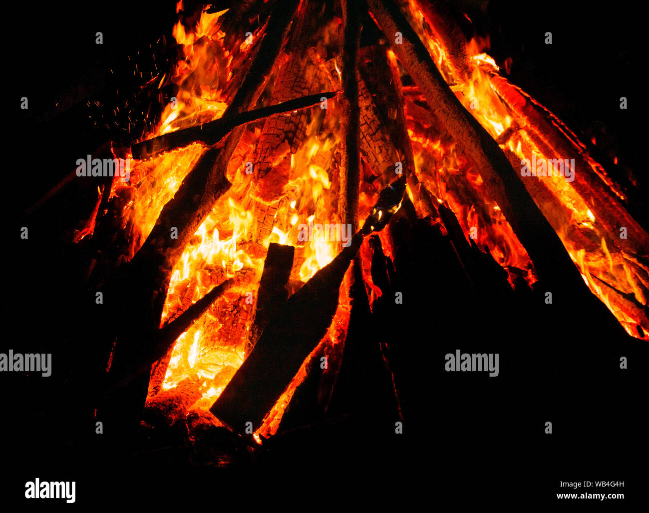 background - flame over burning coals in the darkness Stock Photo - Alamy