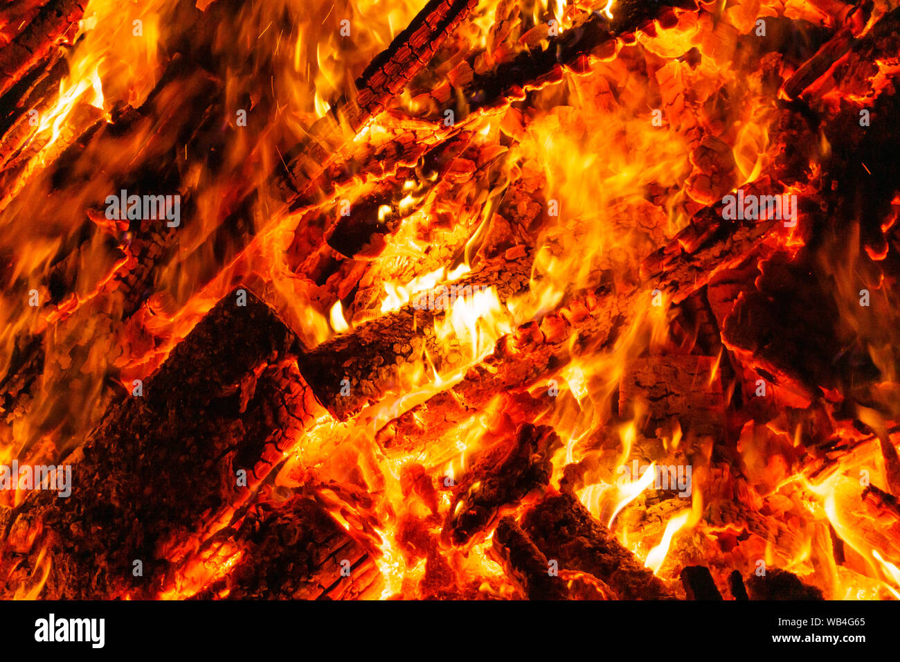 background - flame over burning coals in the darkness Stock Photo - Alamy