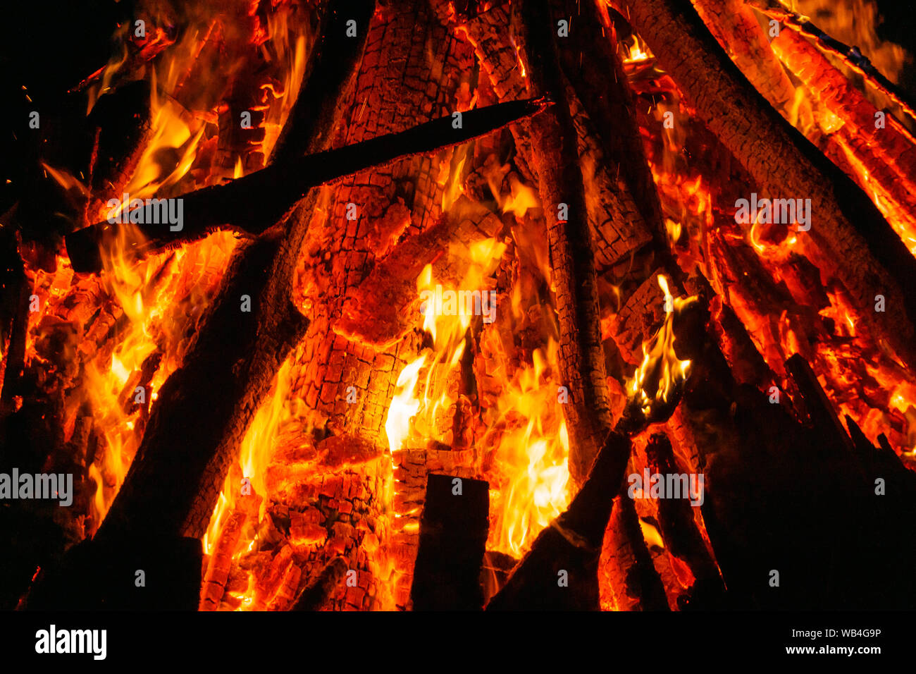background - flame over burning coals in the darkness Stock Photo - Alamy