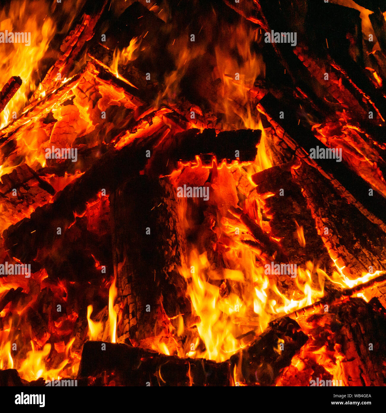 background - flame over burning coals in the darkness Stock Photo - Alamy