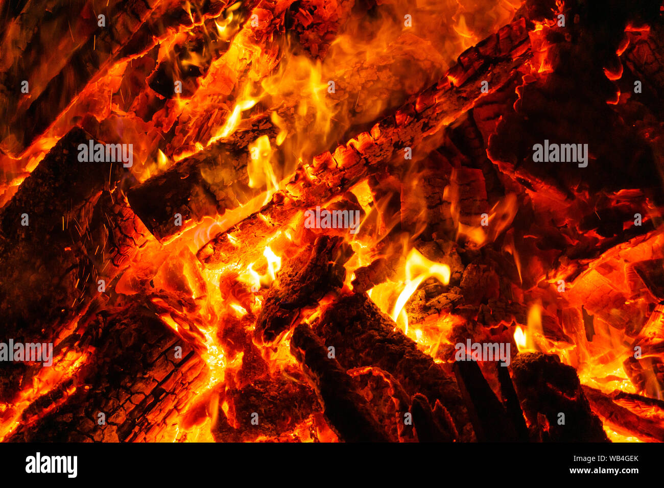 background - flame over burning coals in the darkness Stock Photo - Alamy