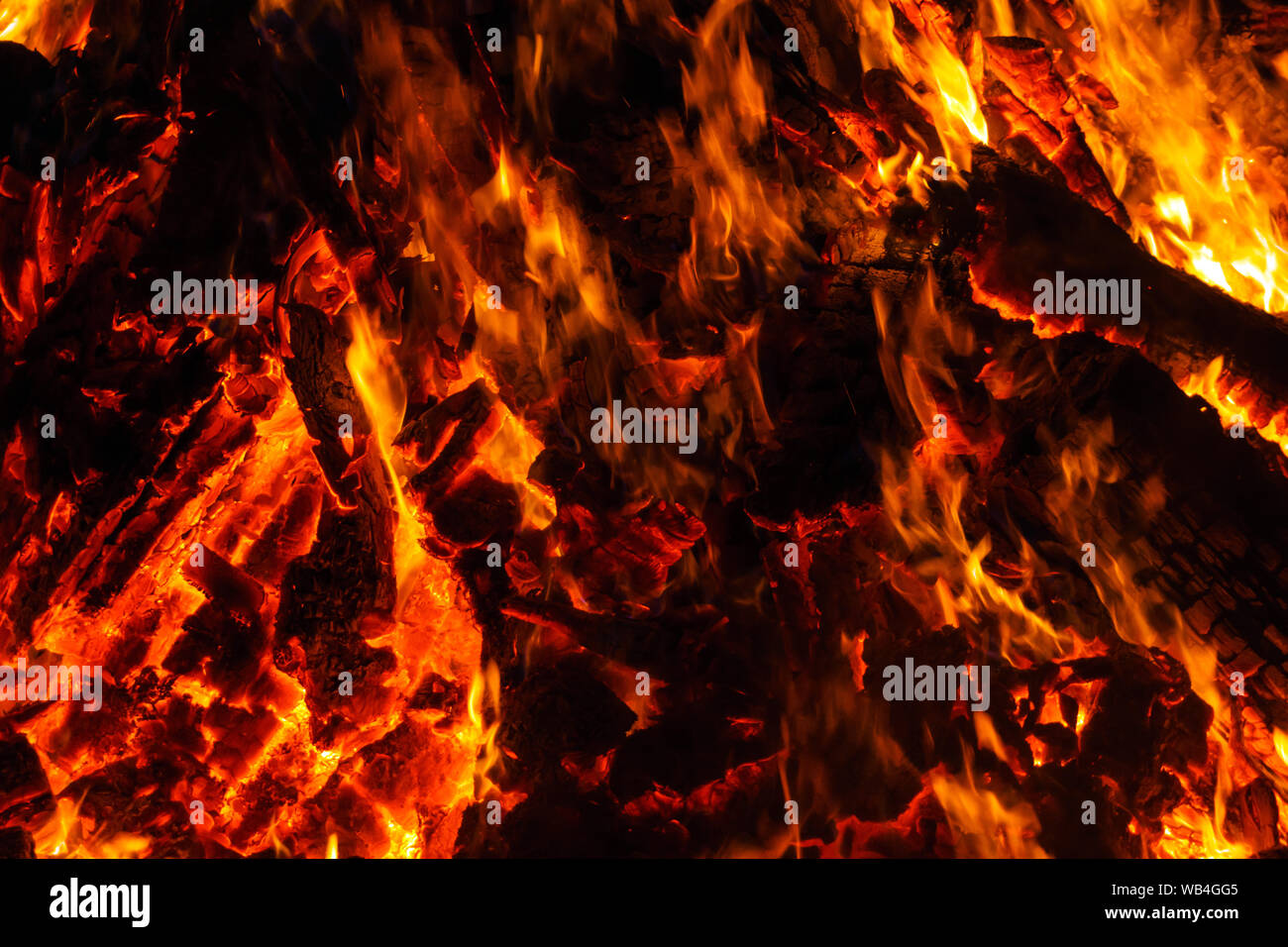 background - flame over burning coals in the darkness Stock Photo - Alamy