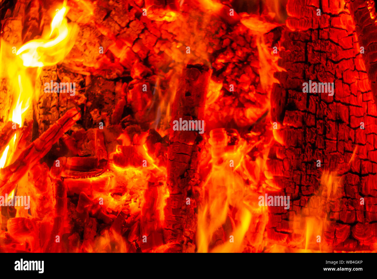 background - flame over burning coals in the darkness Stock Photo - Alamy