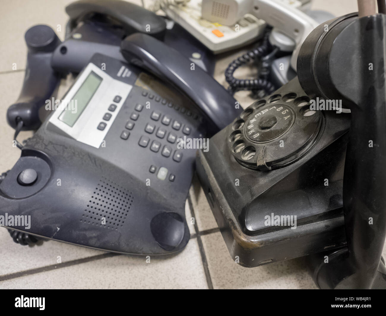 A bunch of old phones on the floor Stock Photo - Alamy