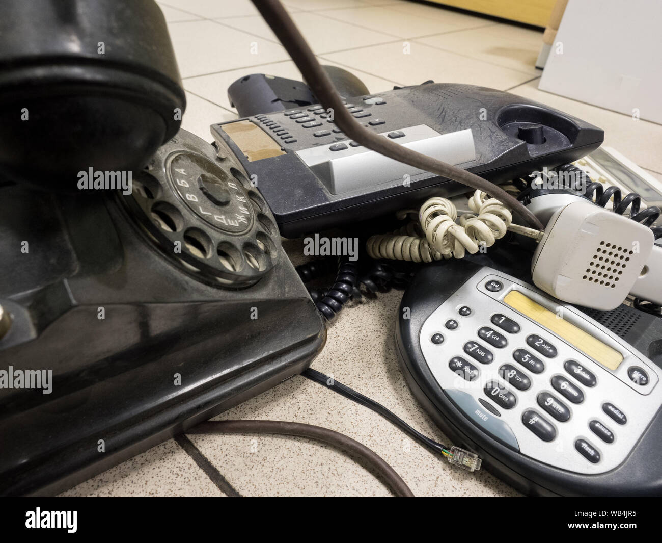 A bunch of old phones on the floor Stock Photo - Alamy