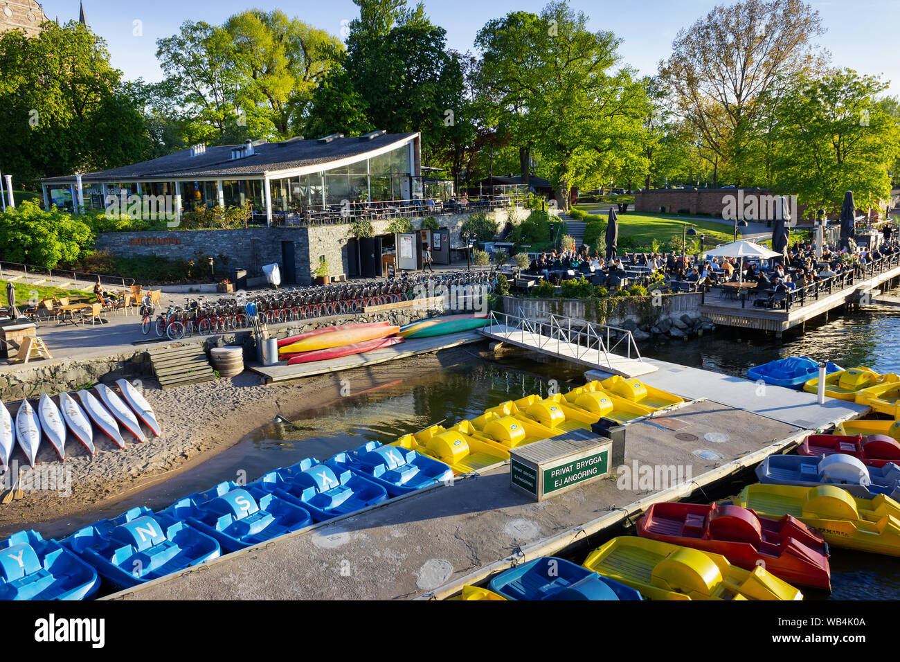 Crowded floating dock-restaurants and coffee shops with sports rental ...