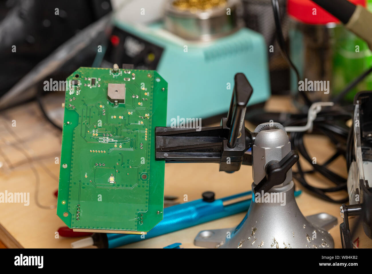 Printed circuit board in vice on workbench for repair Stock Photo - Alamy