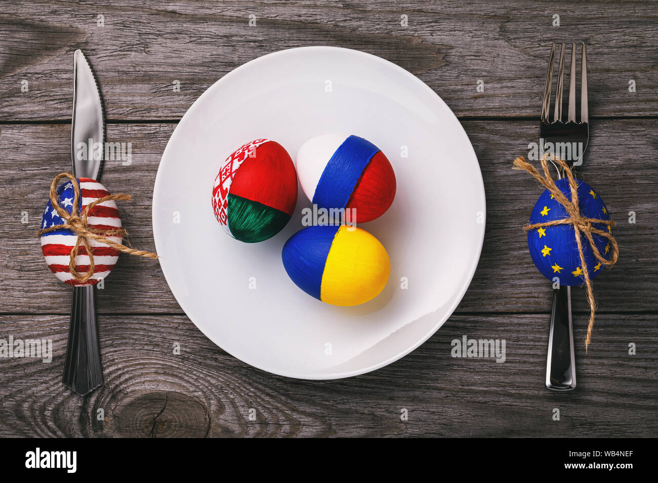 Three easter eggs painted in the color of the flags of Russia, Ukraine ...